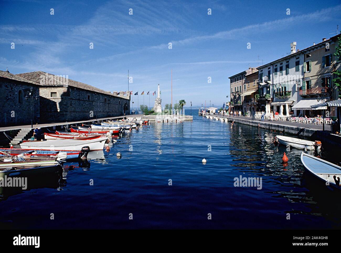 Boats anchoring at the southeastern lakefront of Lake Garda in the old ...