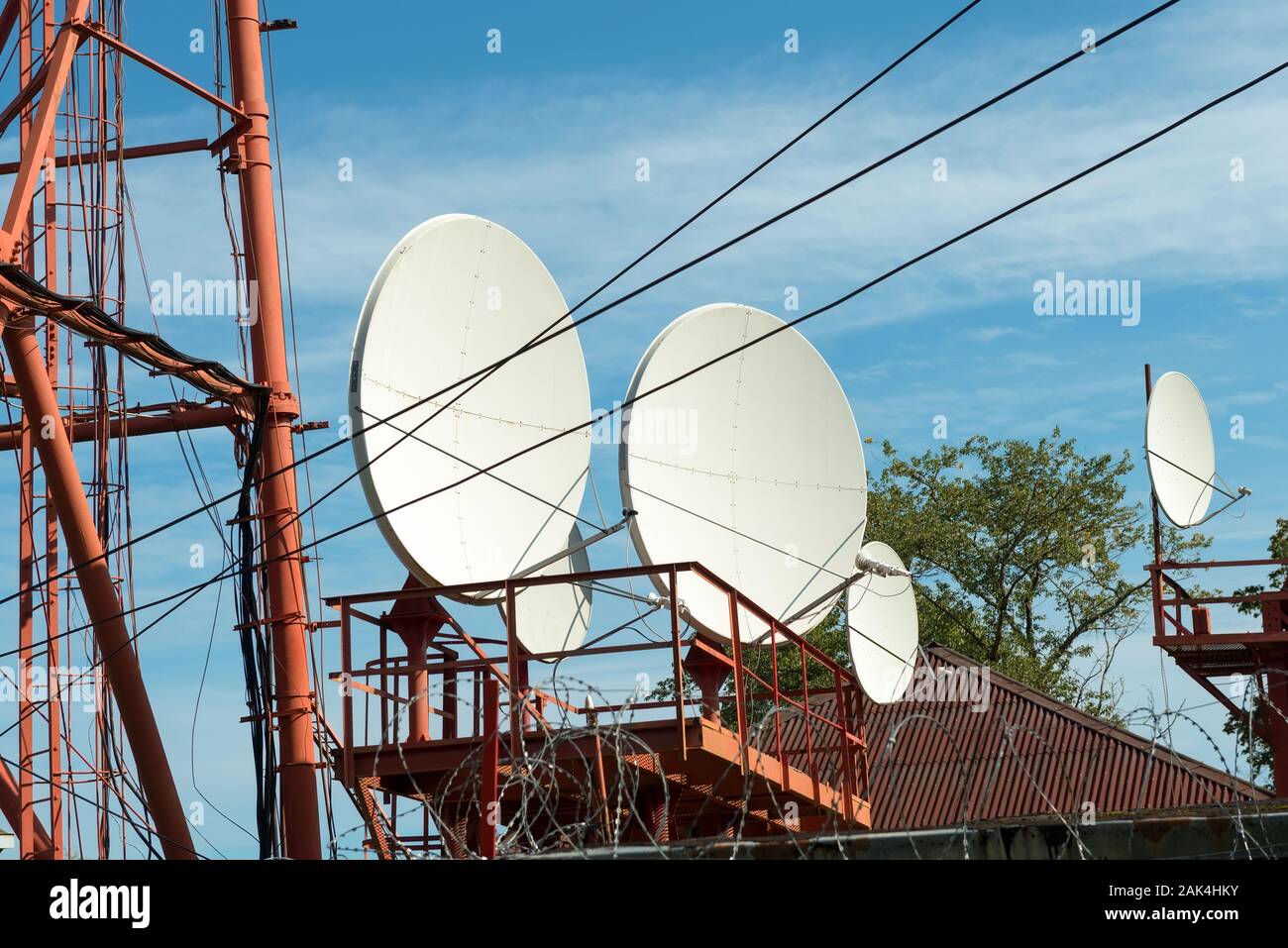 A white radio telecommunications satellite dishes installed on the roof ...