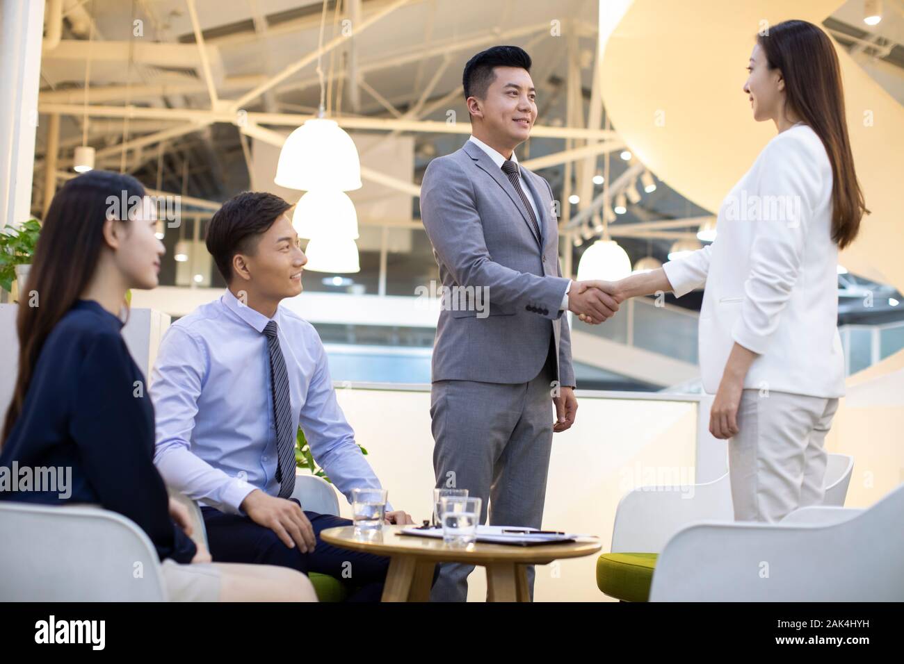 Authority leadership shaking hands smiling face to face standing hi-res stock photography and ...