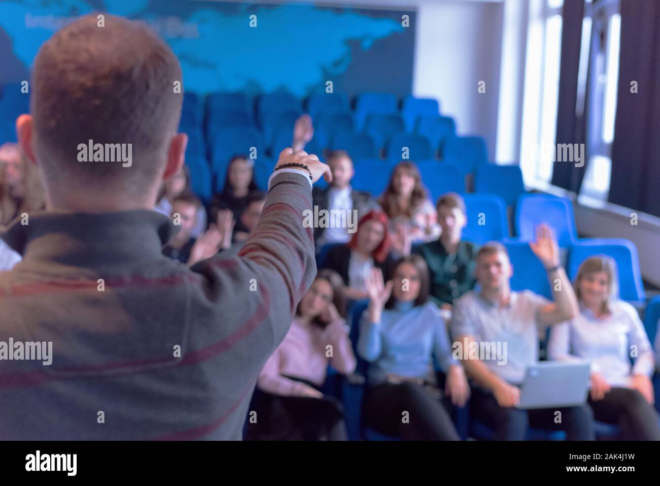 Education process at professor`s lecture in audience. Young male ...
