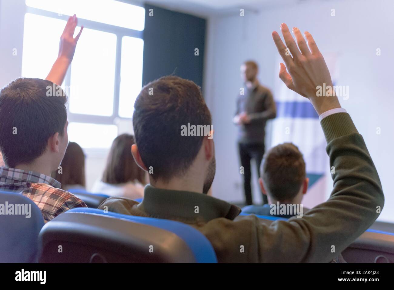 Education process at professor`s lecture in audience. Young male ...