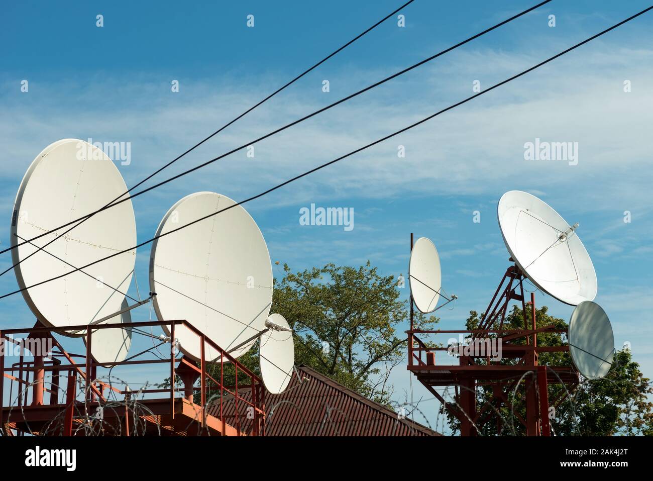 A white radio telecommunications satellite dishes installed on the roof ...