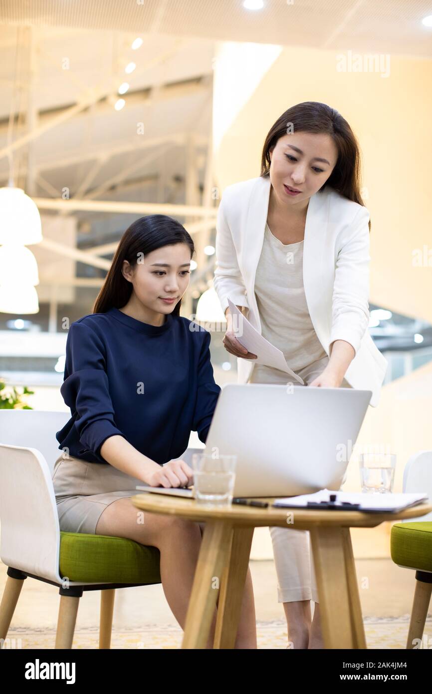 Chinese businesswomen working in office Stock Photo - Alamy