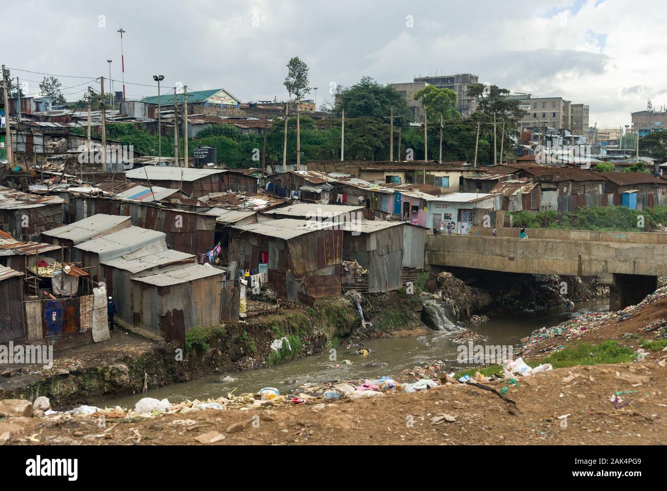 Mathare river with metal shacks lining it flowing through Mathare slum ...