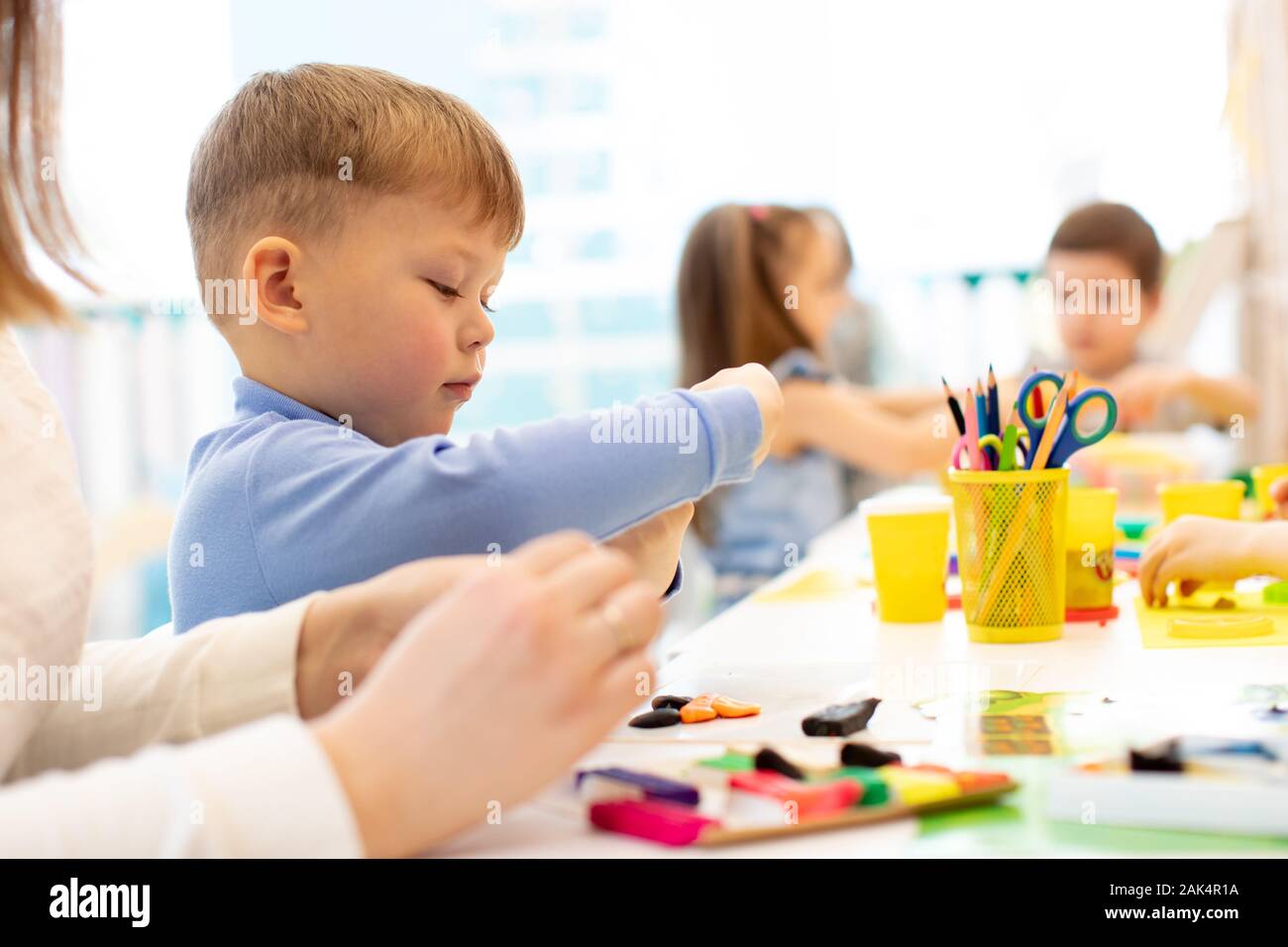 Children creativity. Kids sculpts from clay. Cute little boy moulds ...