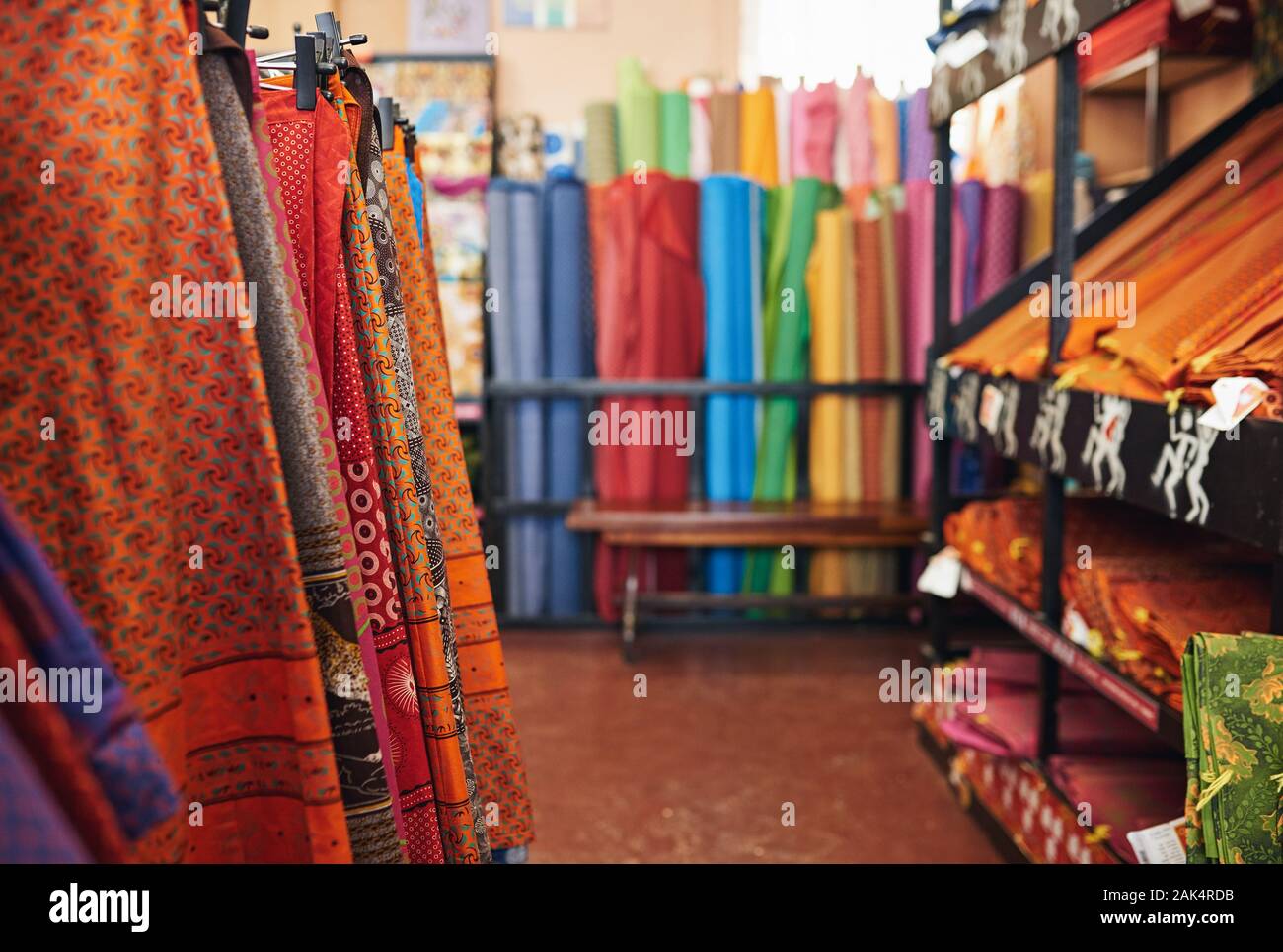 Colorful printed textiles on display in a fabric store Stock Photo - Alamy