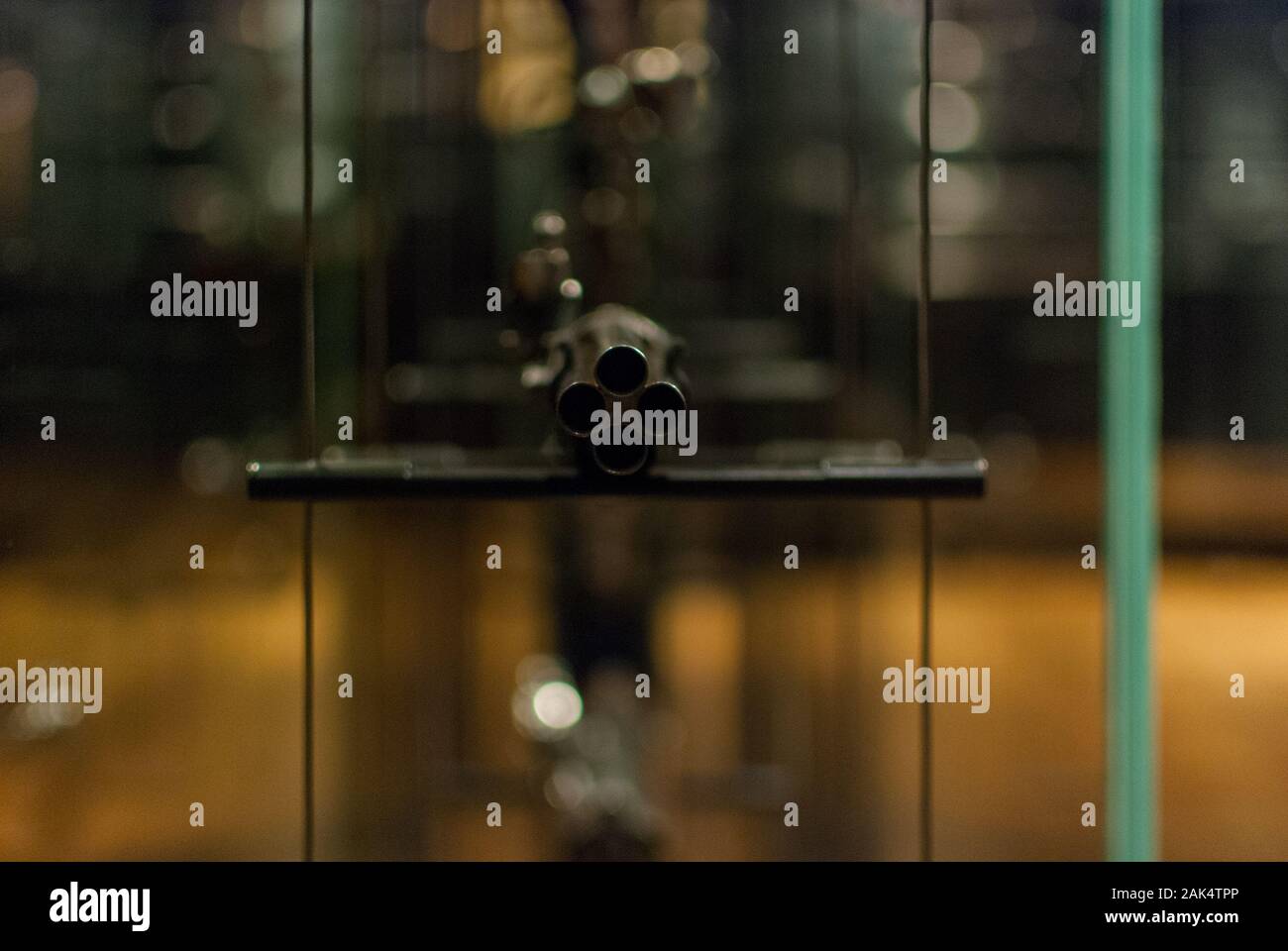 Old gun displayed in the window of a museum Stock Photo - Alamy