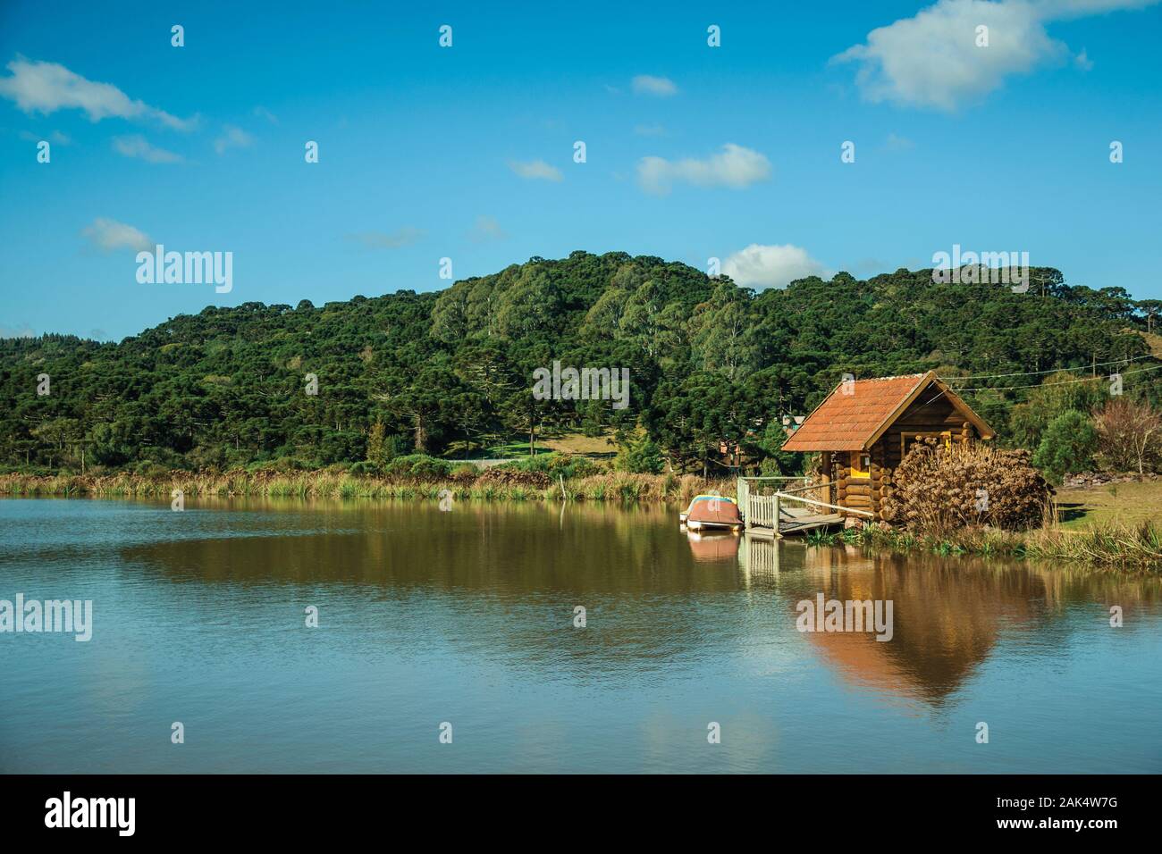 Small rustic shack reflected on the lakeside of crystal clear water ...