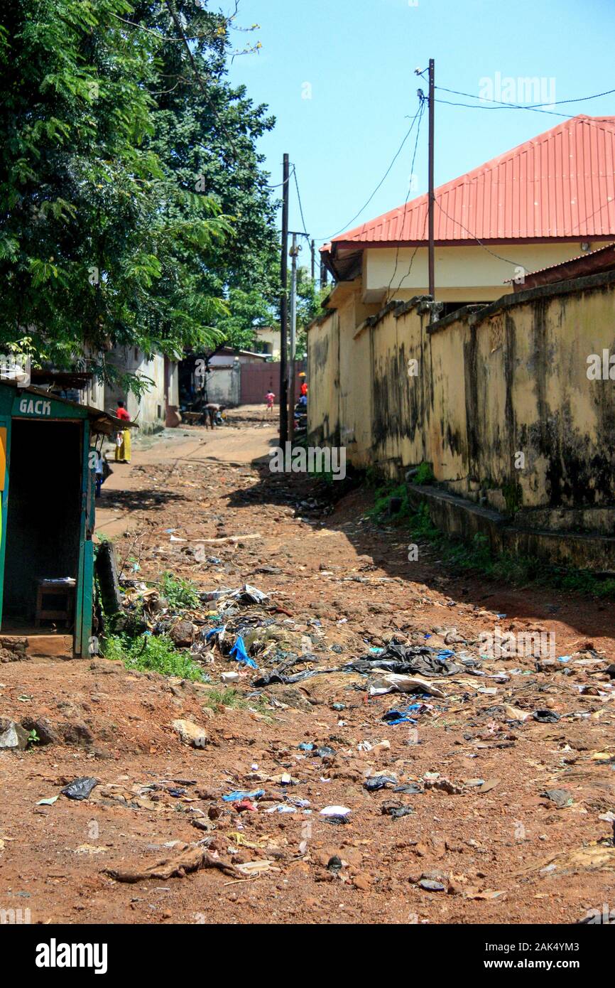 View of a typical street in Conakry, Guinea, West Africa, full of trash ...
