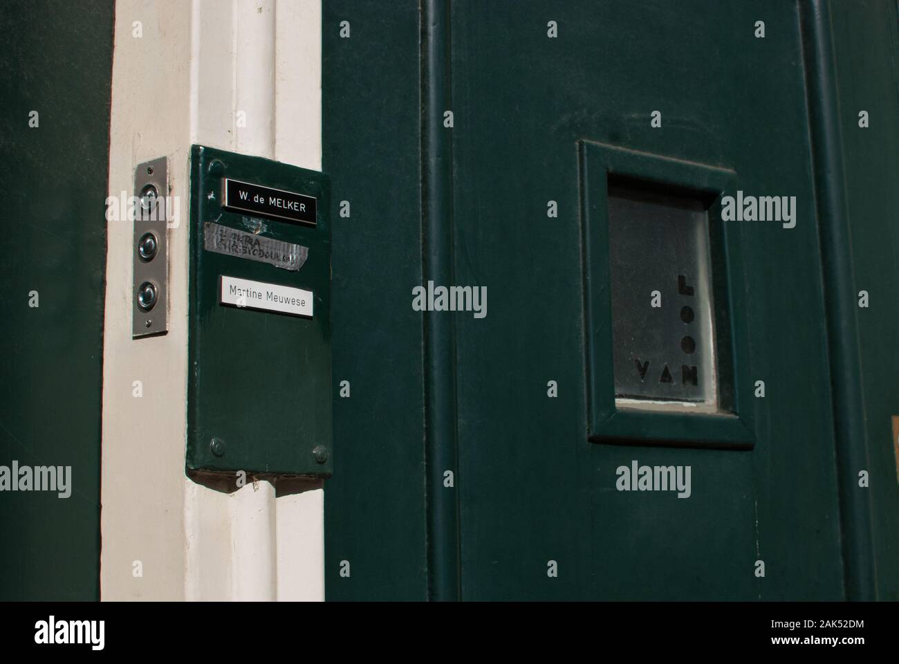 Green german door with frosted glass in the middle and doorbel by the ...
