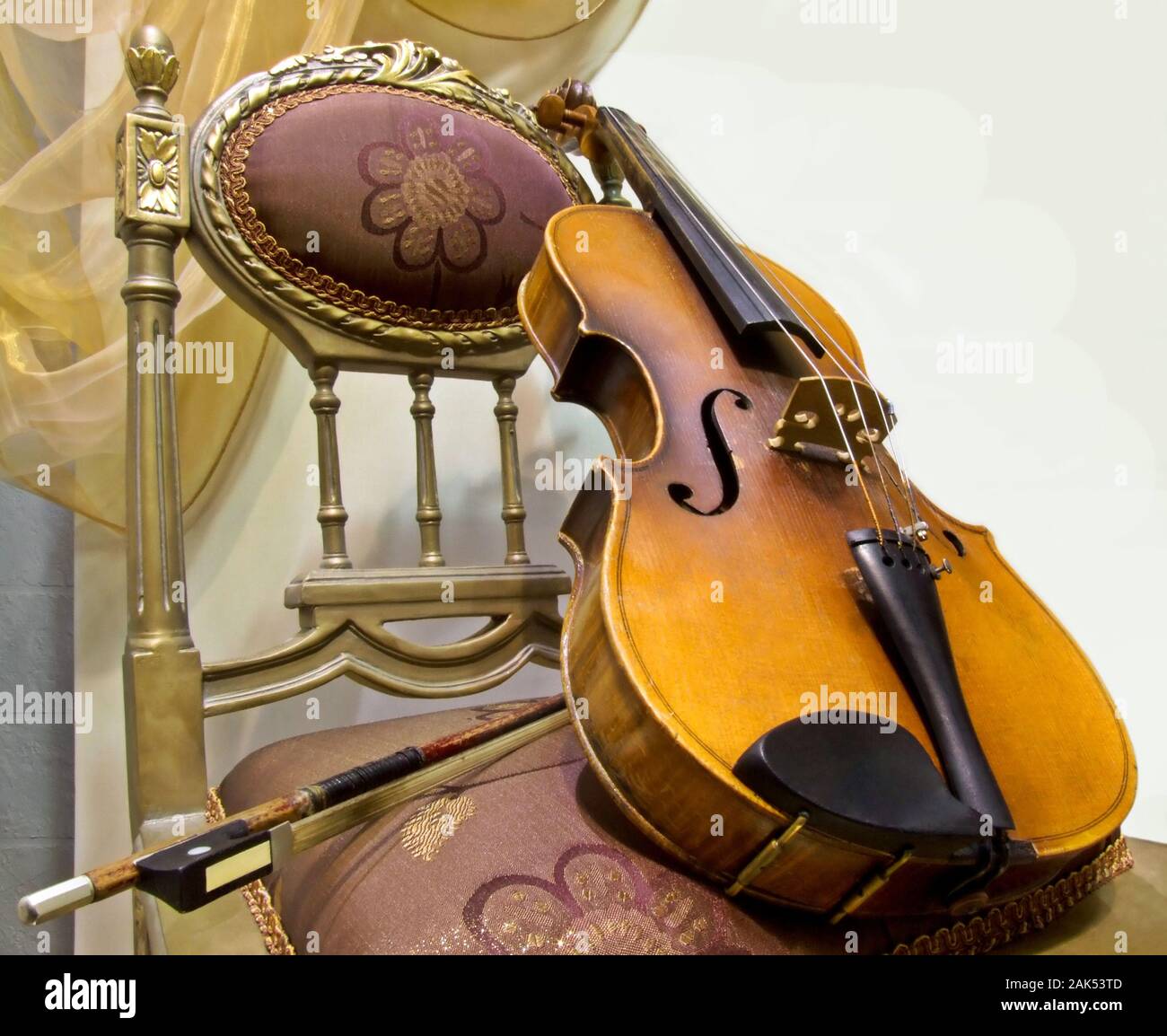 Old music instrument violin on the chair Stock Photo - Alamy