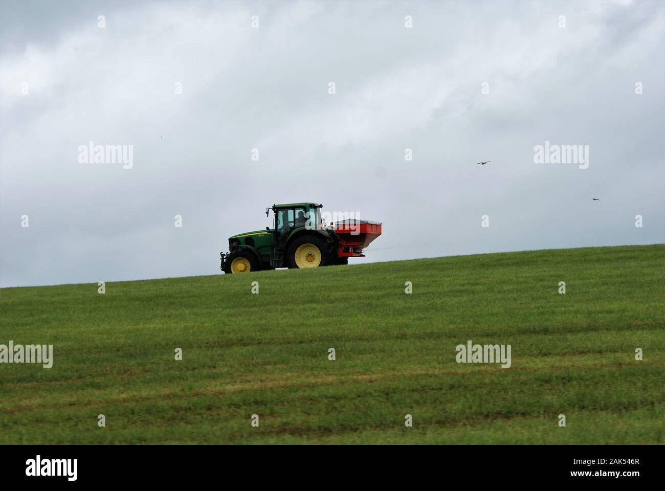 Tractor on farmland Stock Photo - Alamy