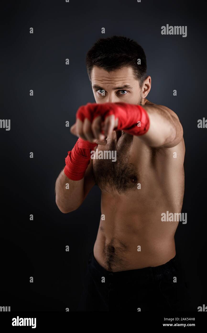 Sportsman boxer throwing a fierce and powerful punch. muscular man on ...