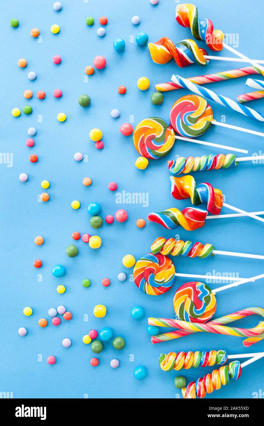 Colorful sweets and lollipops on a blue background Stock Photo - Alamy