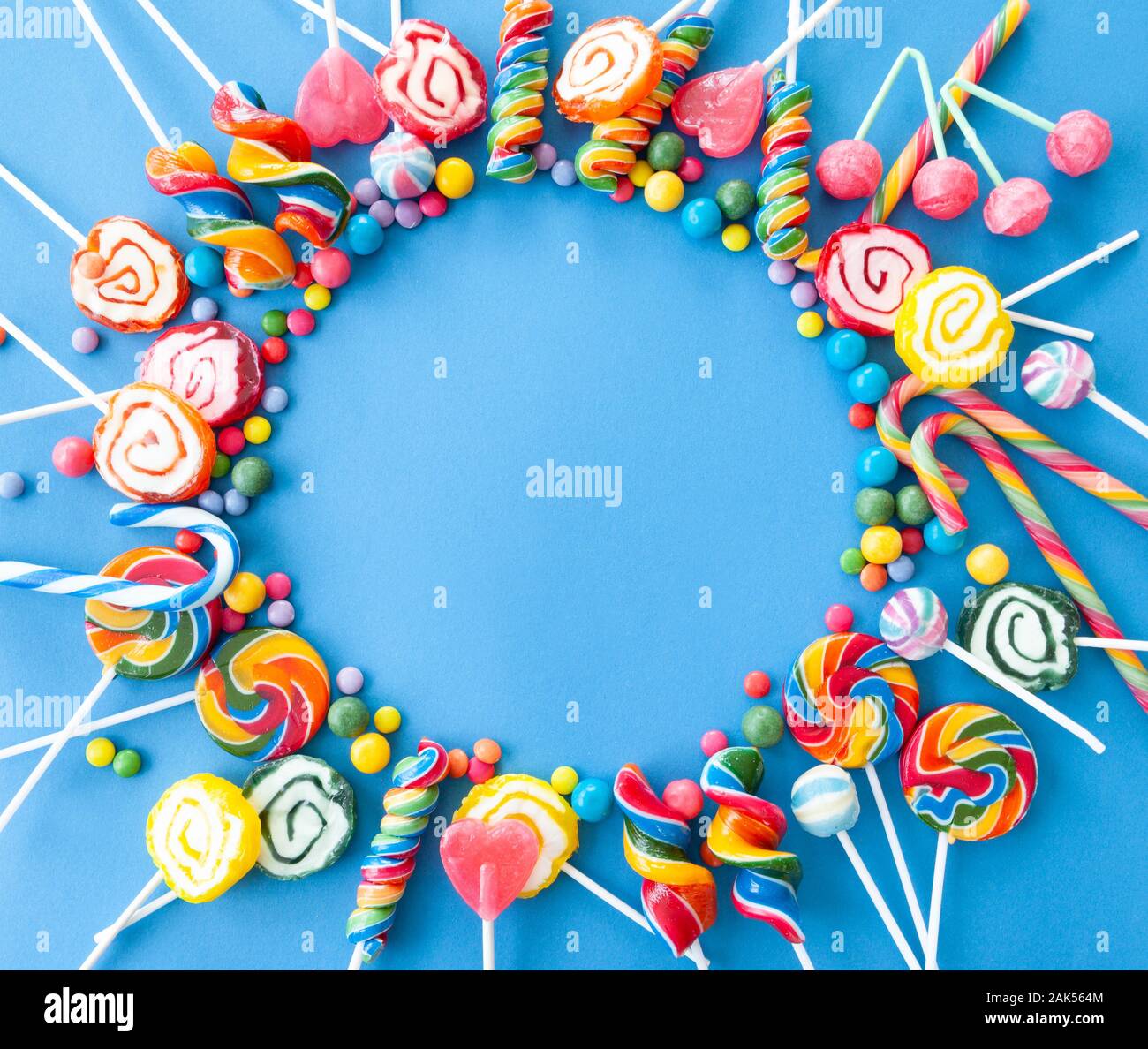 Colorful sweets and lollipops on a blue background Stock Photo - Alamy