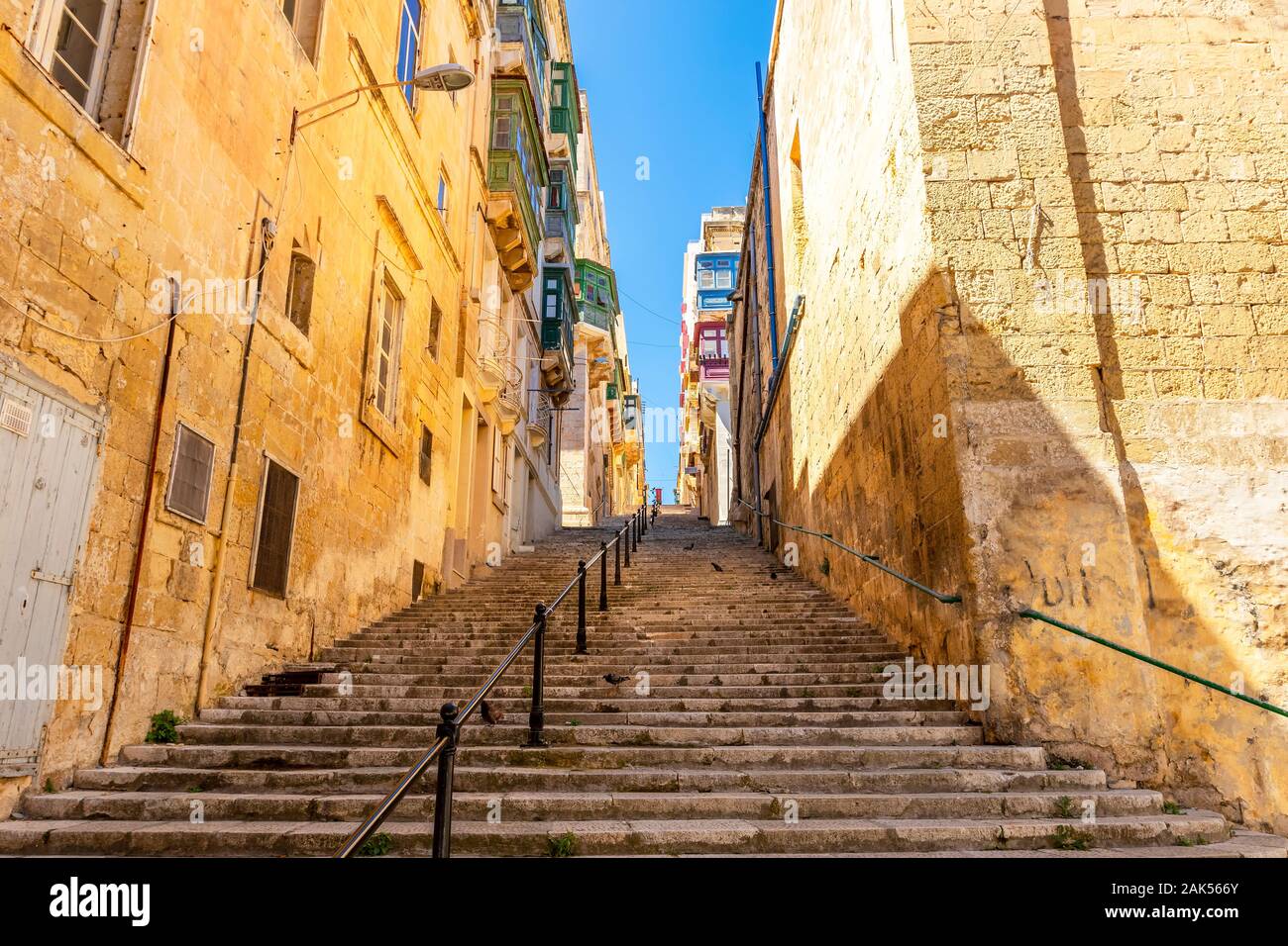 Maltese narrow street with long staircase in Valletta, Malta Stock ...