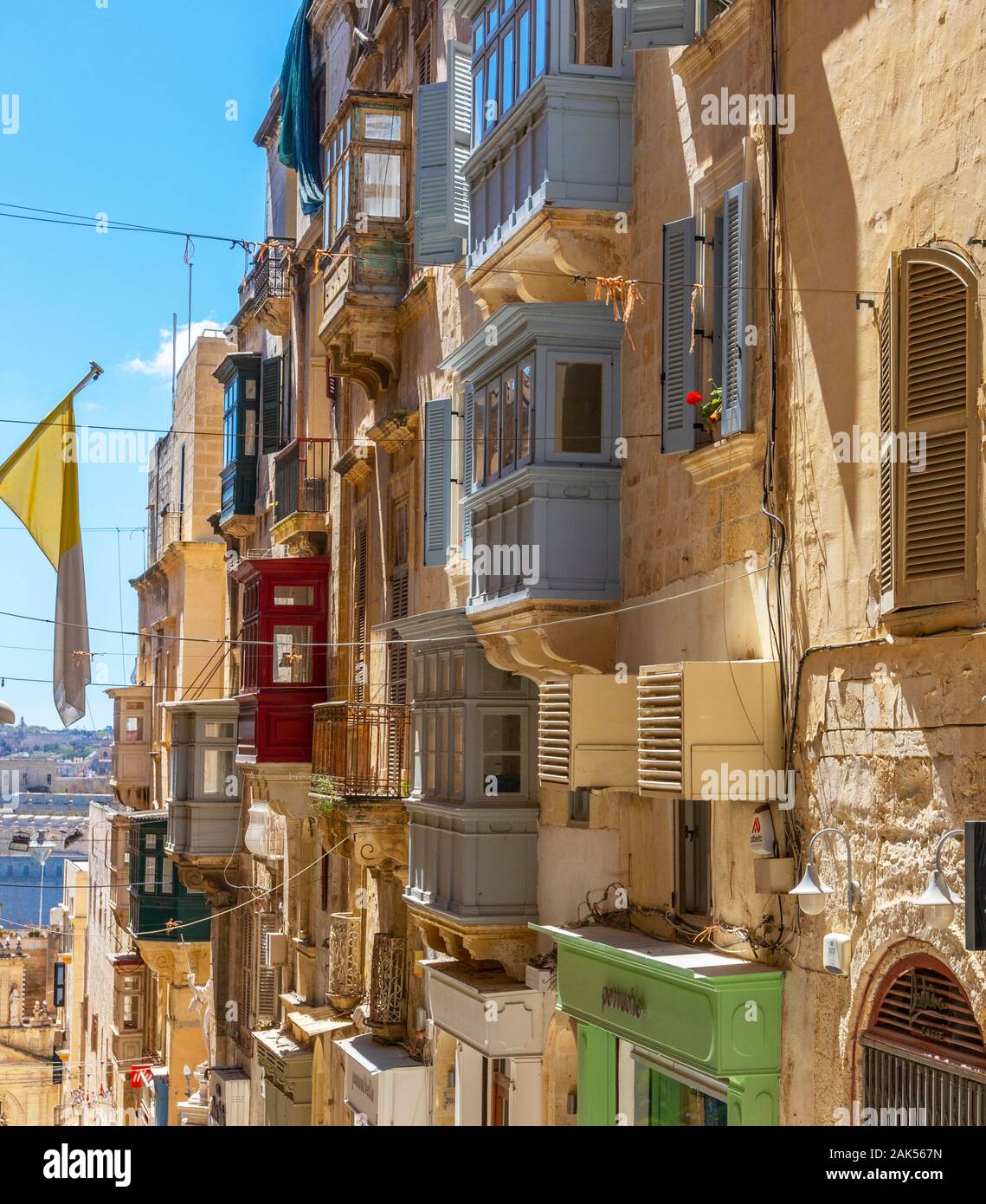 Typical narrow maltese streets with colorful traditional windows and ...