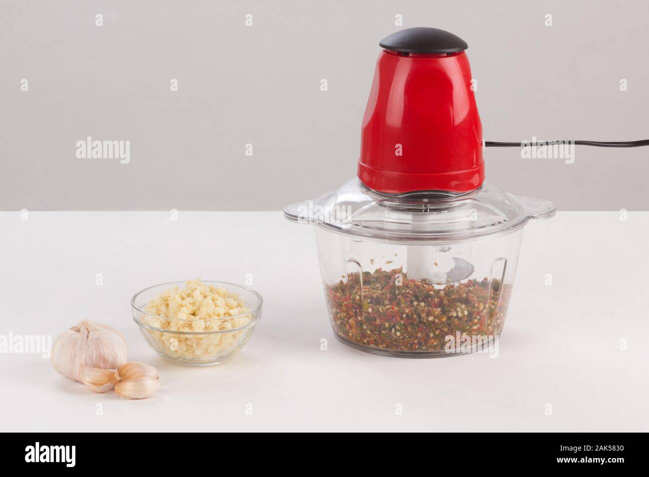 Food processor with chopped chilli inside isolated on white background ...