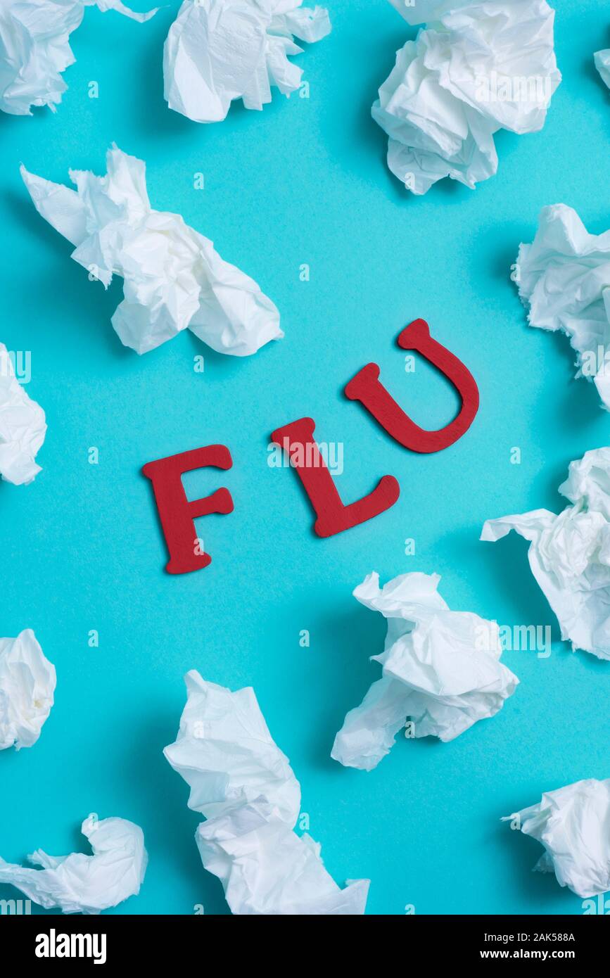a pile of used tissues and the word flu on a blue background Stock ...