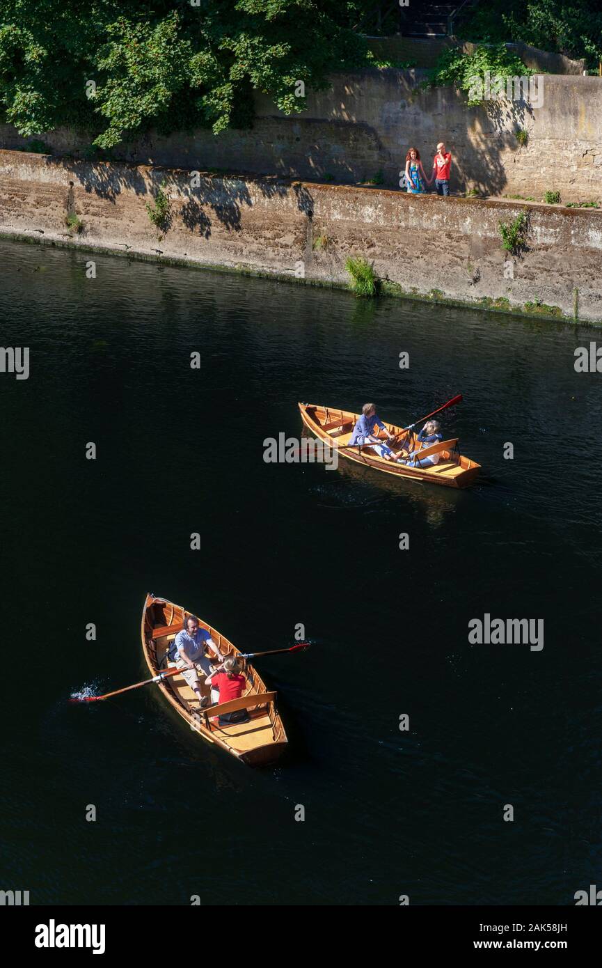 Pleasure boating on calm water. Couples in rowing boats on the river ...