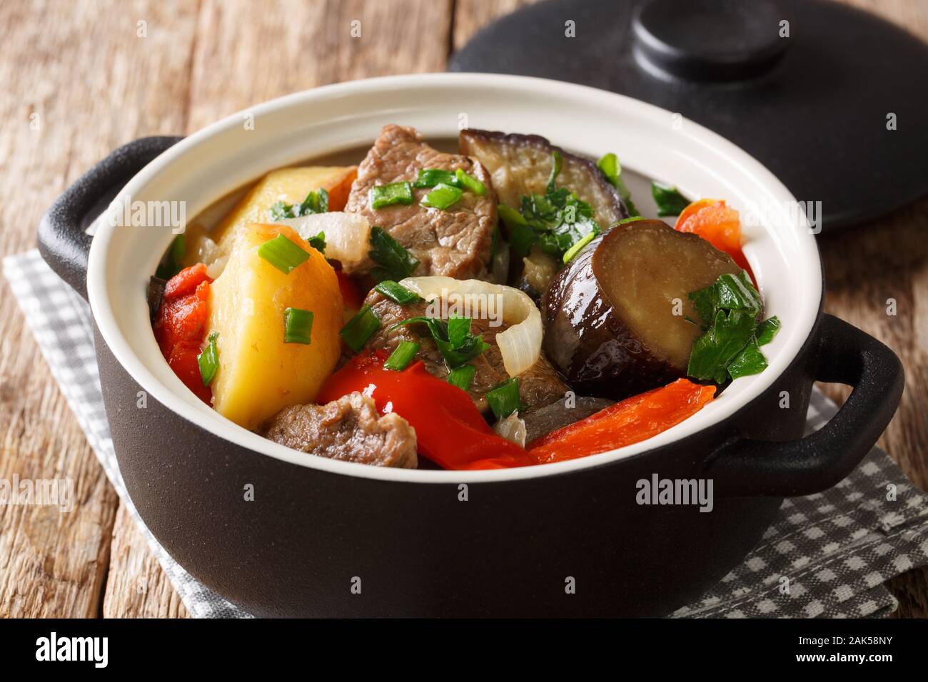 Tasty Georgian Chanakhi stew of meat and vegetables in a pot close-up ...