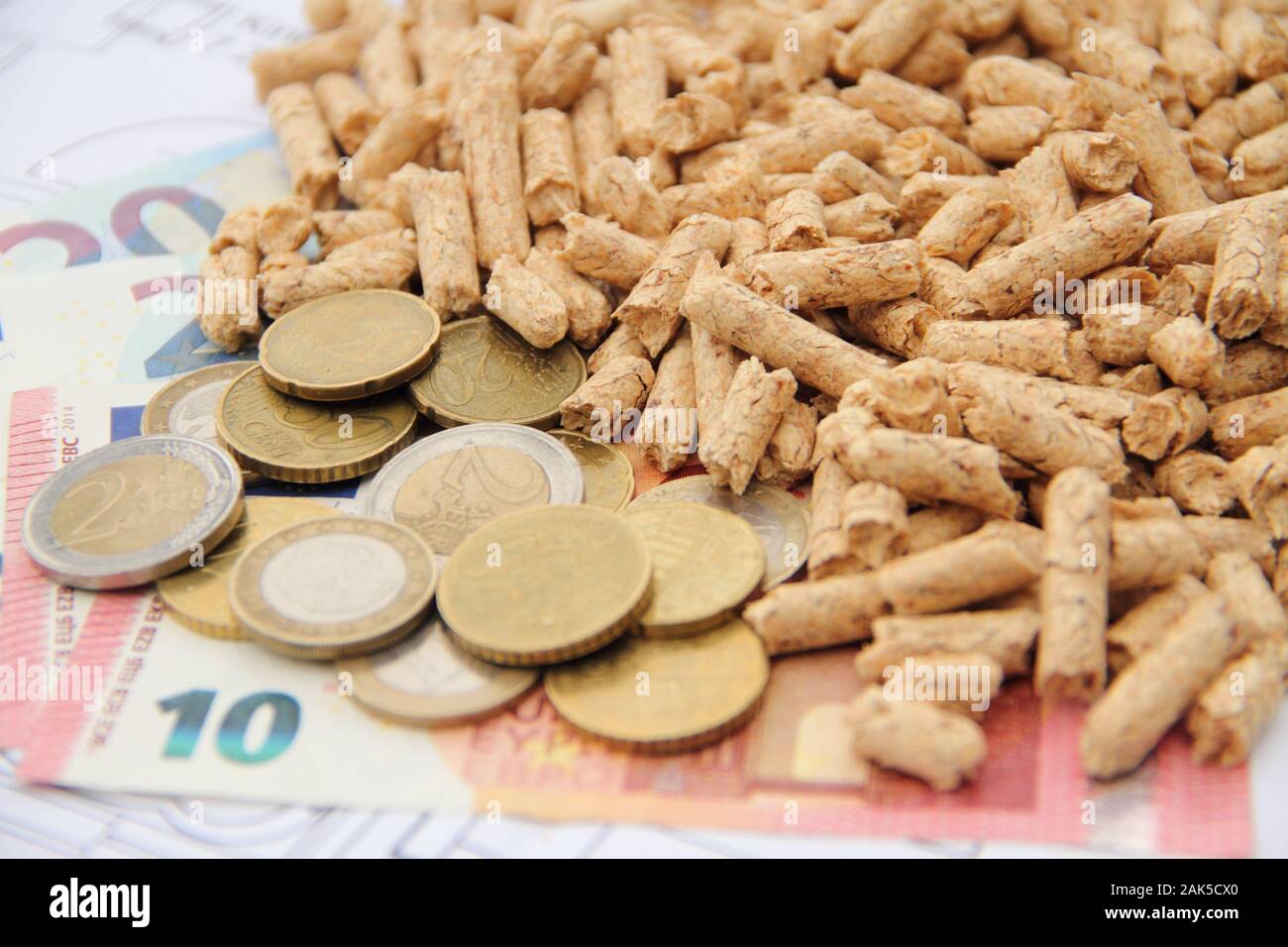 wood pellets with money on a floor plan Stock Photo - Alamy