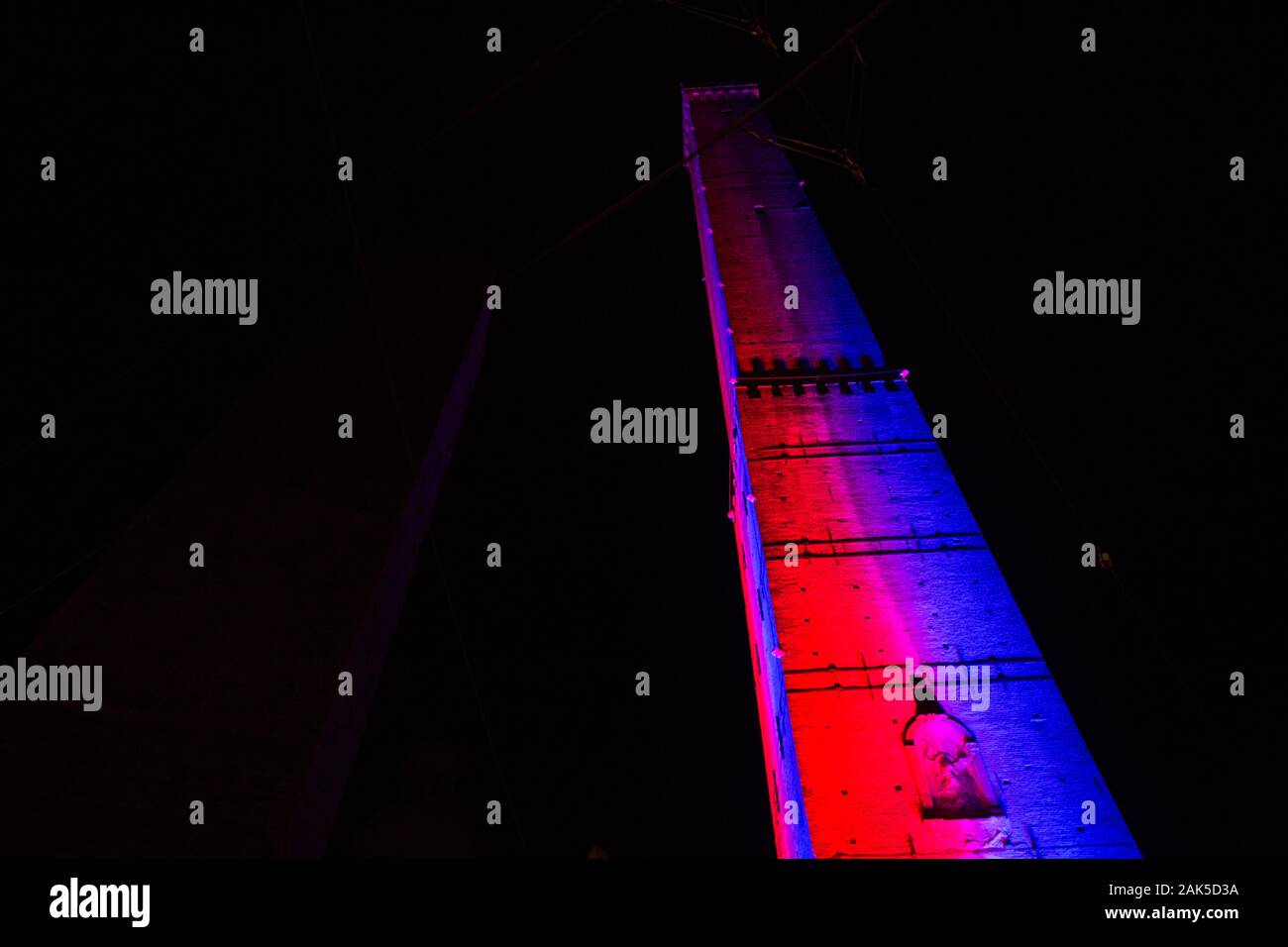 Bologna, Main Tower is lighted in blue and red, the colors of Bologna's ...