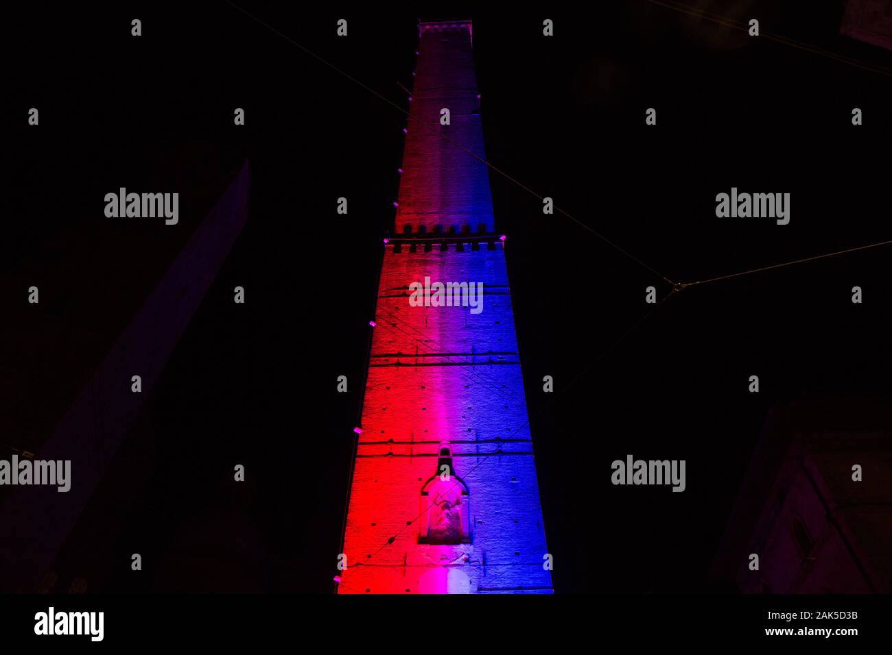 Bologna, Main Tower is lighted in blue and red, the colors of Bologna's ...