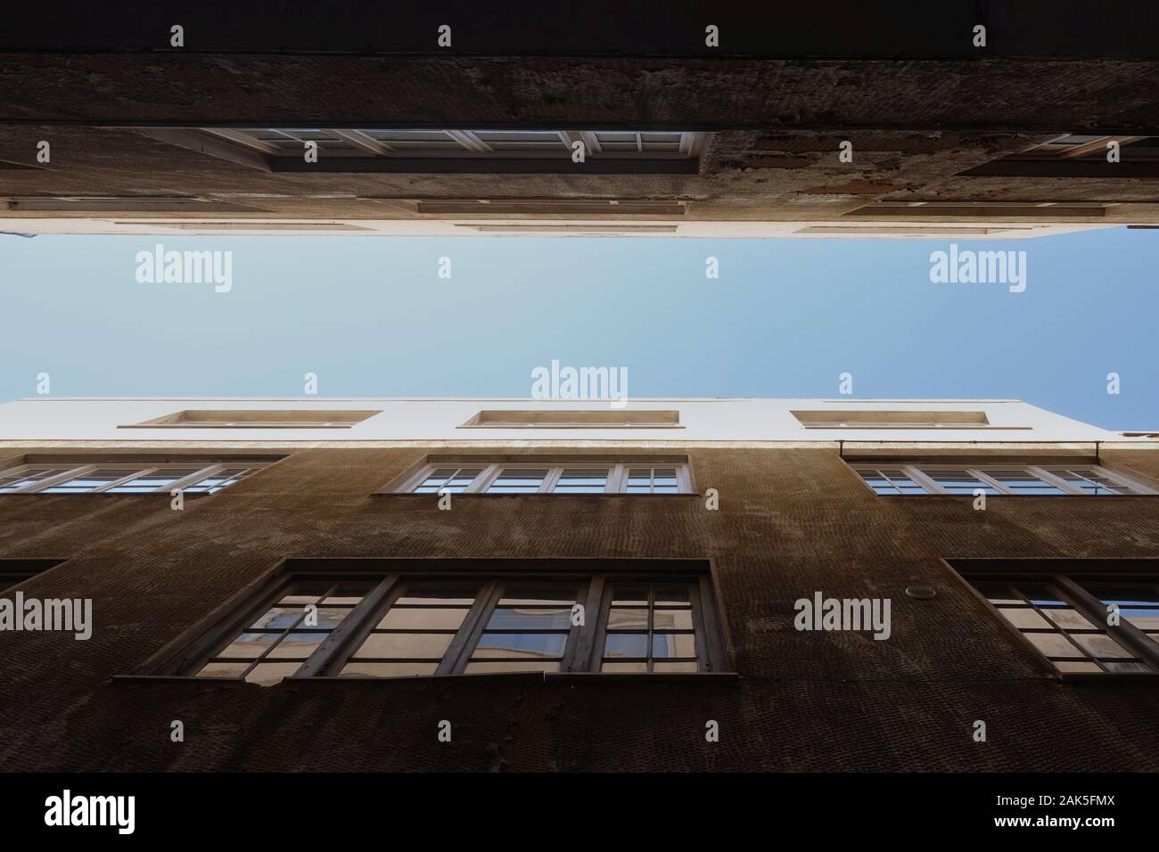 Patch of blue sky between two old buildings. Abstract architectural ...