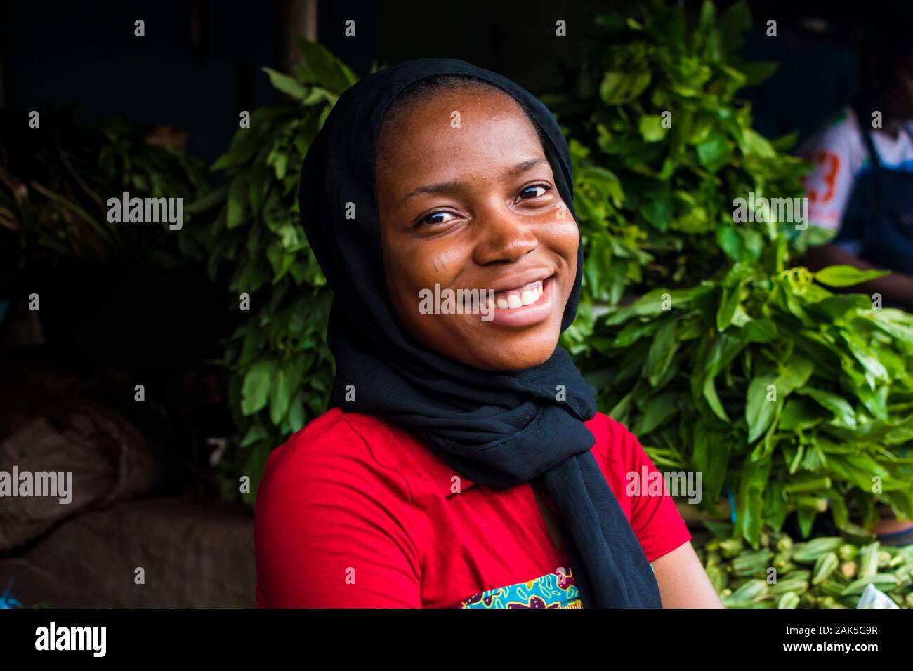 young happy african woman selling in a local market smiling Stock Photo ...