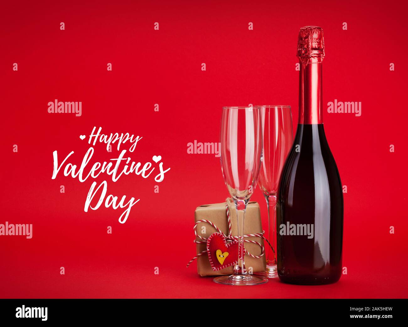 Valentines day gift box and champagne bottle over red background with ...