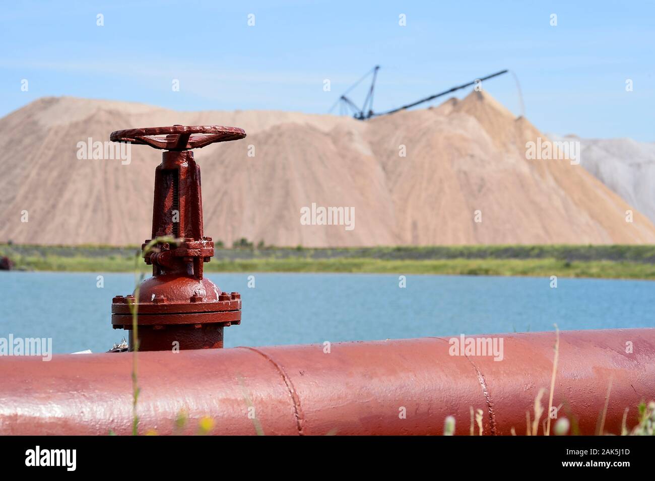 The valve from the pipeline against the background of a salt mine and ...