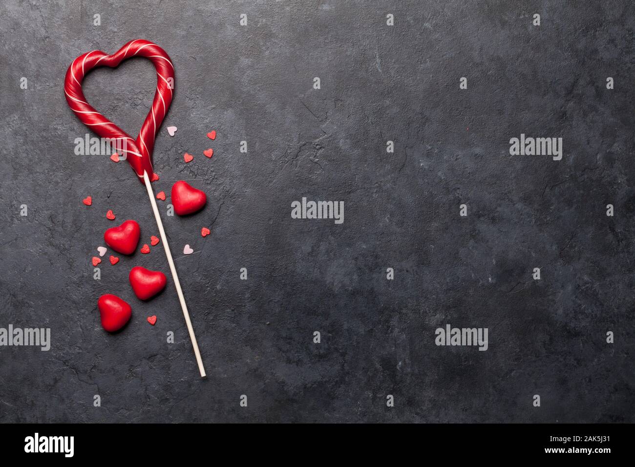 Valentines day greeting card with heart shaped sweets over stone ...
