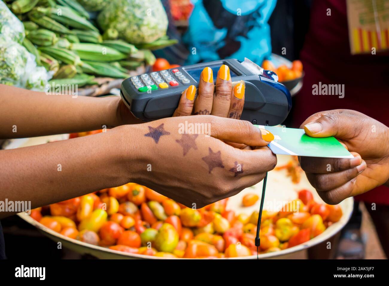 close up of an african woman selling in a local african market holding ...