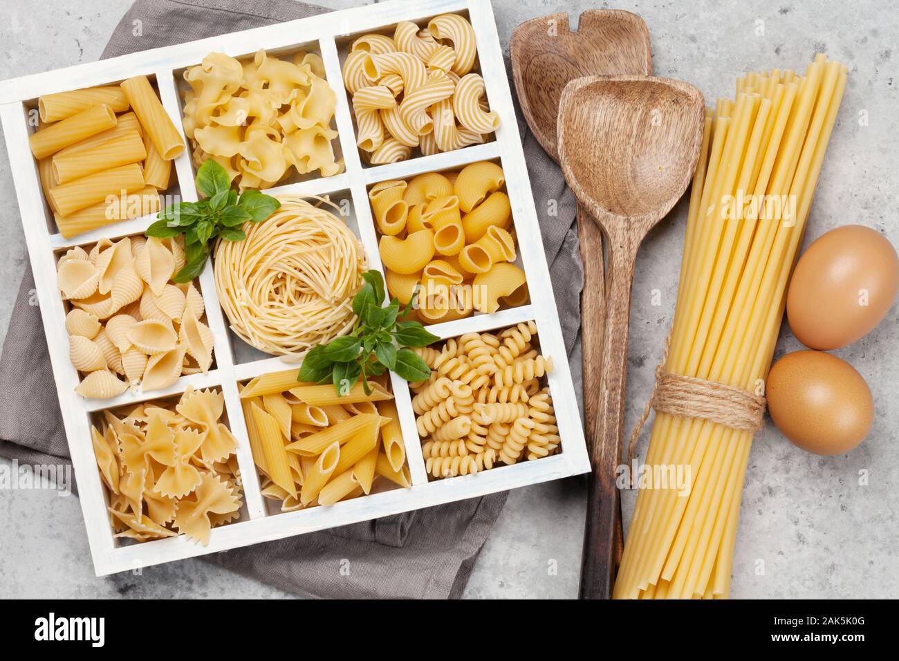 Various pasta in wooden box. Top view flat lay Stock Photo - Alamy