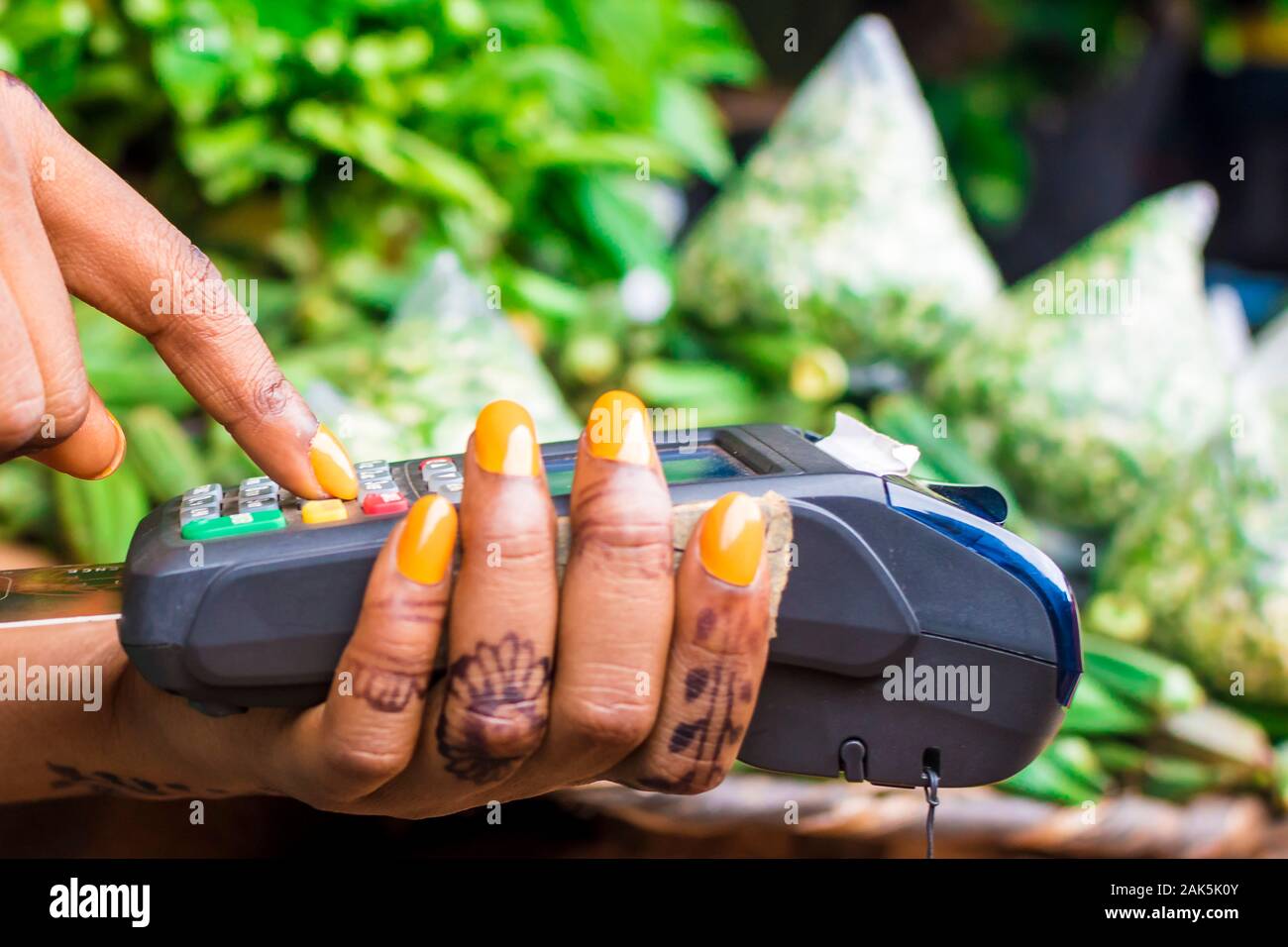 close up of an african woman selling in a local african market using a ...