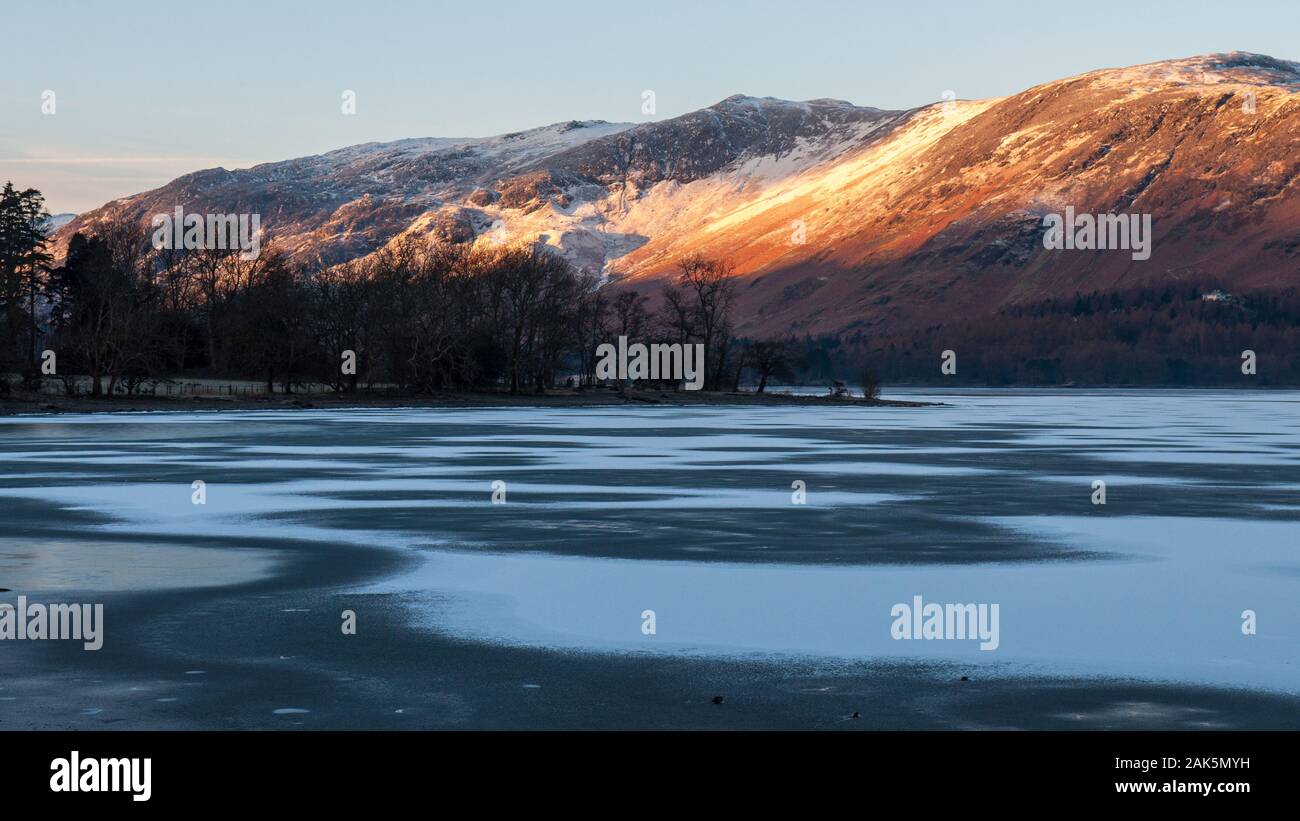 Winter sunrise lights up the snow-dusted slopes of Catbells and Maiden ...