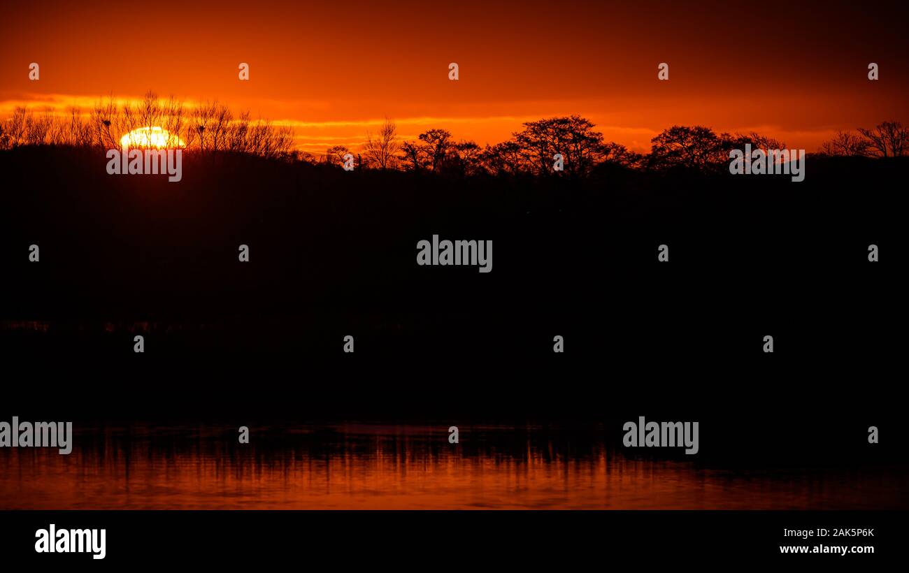 Sunset over the wetlands and woodlands, Lunt Meadows RSPB Nature ...