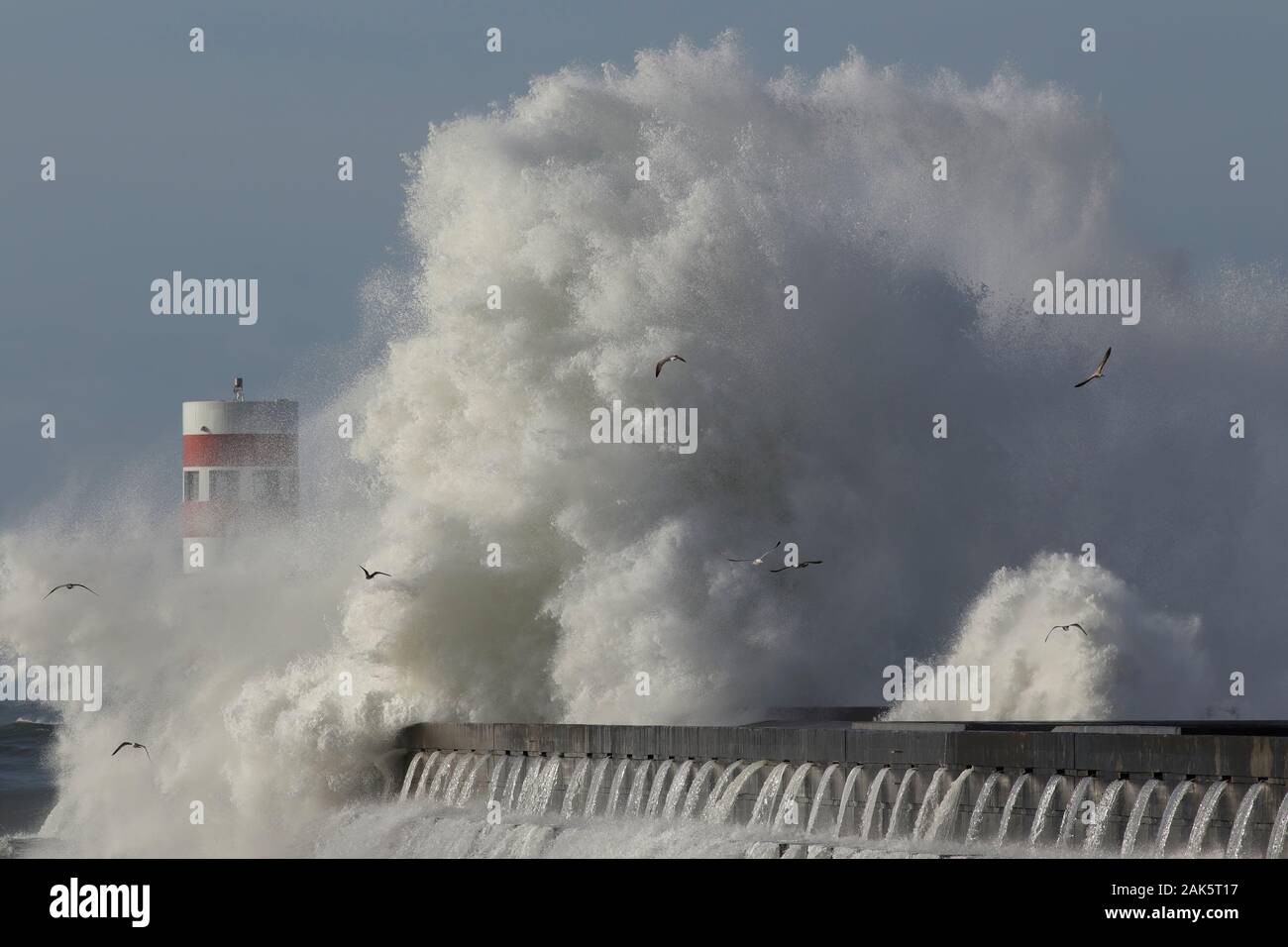 Big wave splash against pier and beacon Stock Photo - Alamy