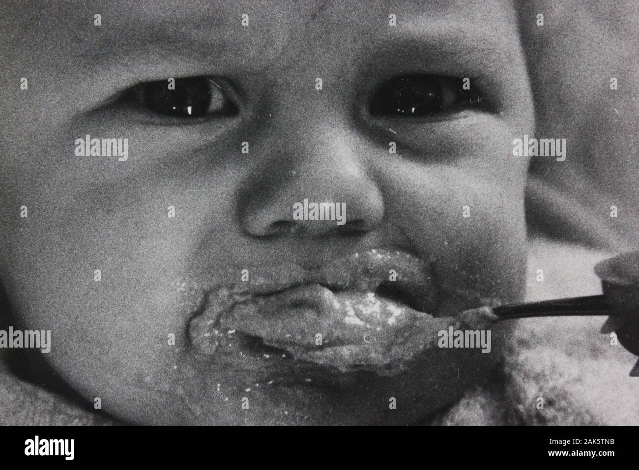Fine 1970s black and white vintage photography of a baby eating ...