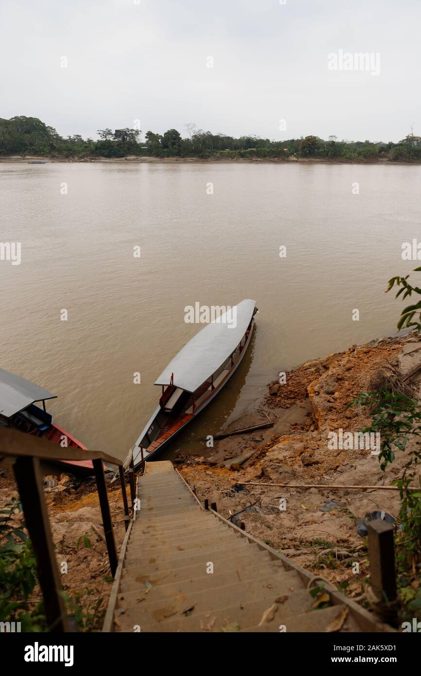 Typical jungle boat on the banks of the Amazonas river with jungle ...