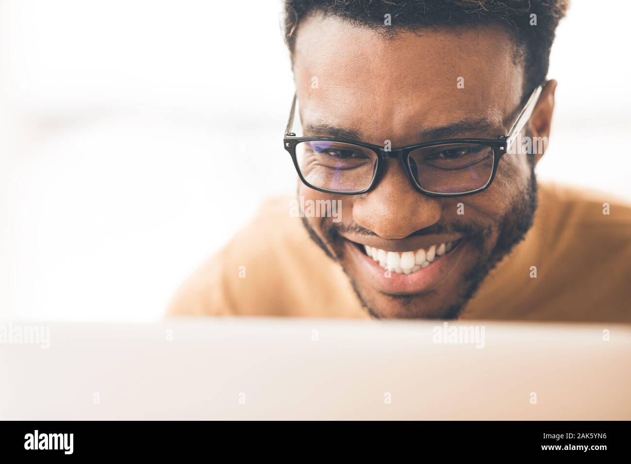 Software Testing. Close up of happy african programmer coding and ...