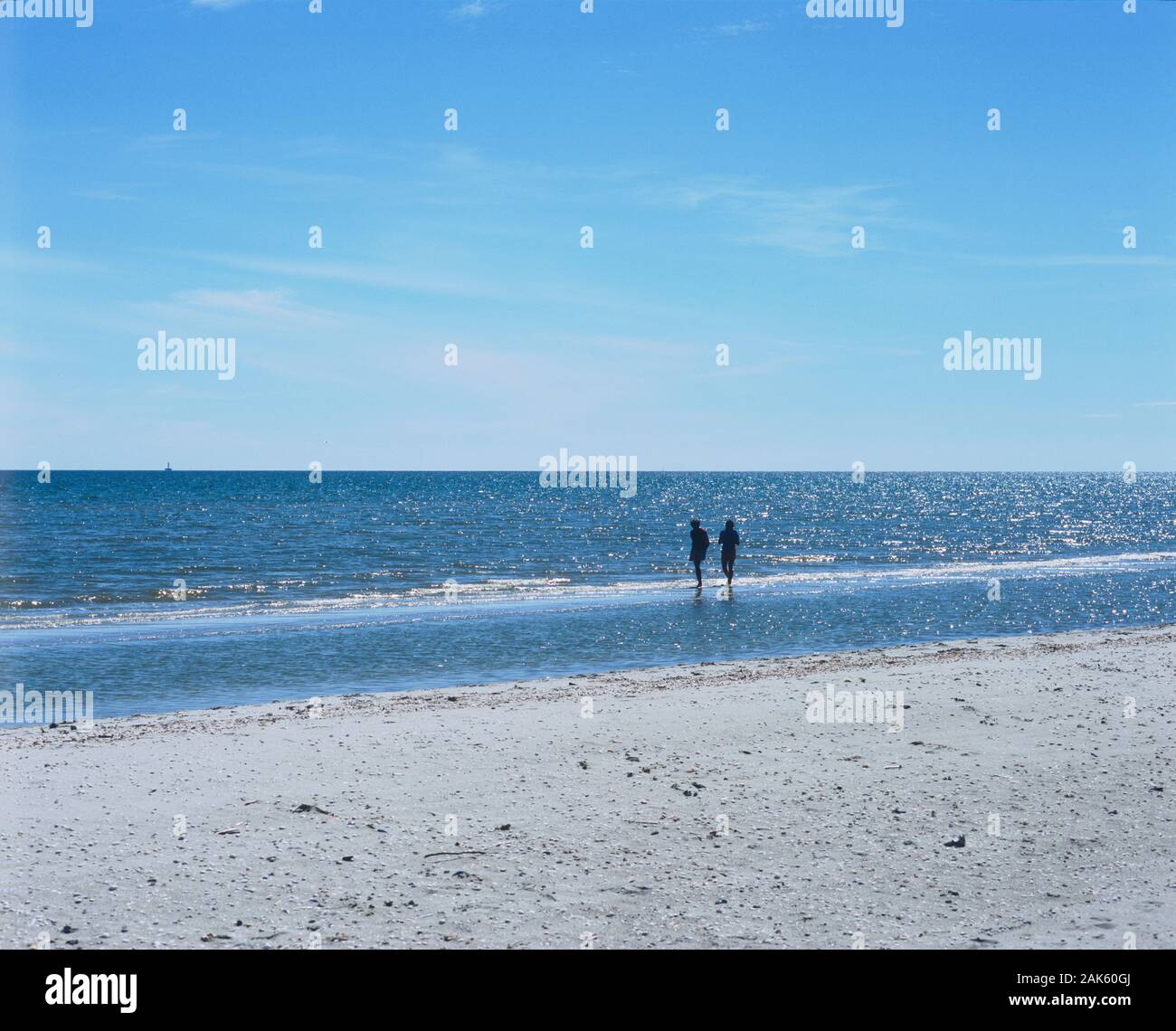 Couple on beach walk Stock Photo - Alamy
