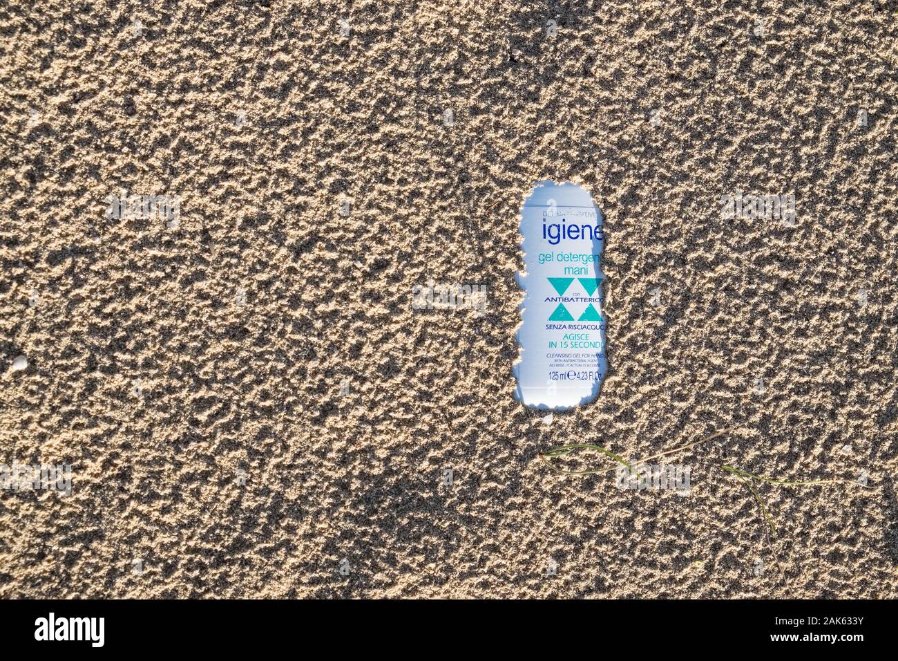 Small white container is embedded in the sand after the rain Stock ...