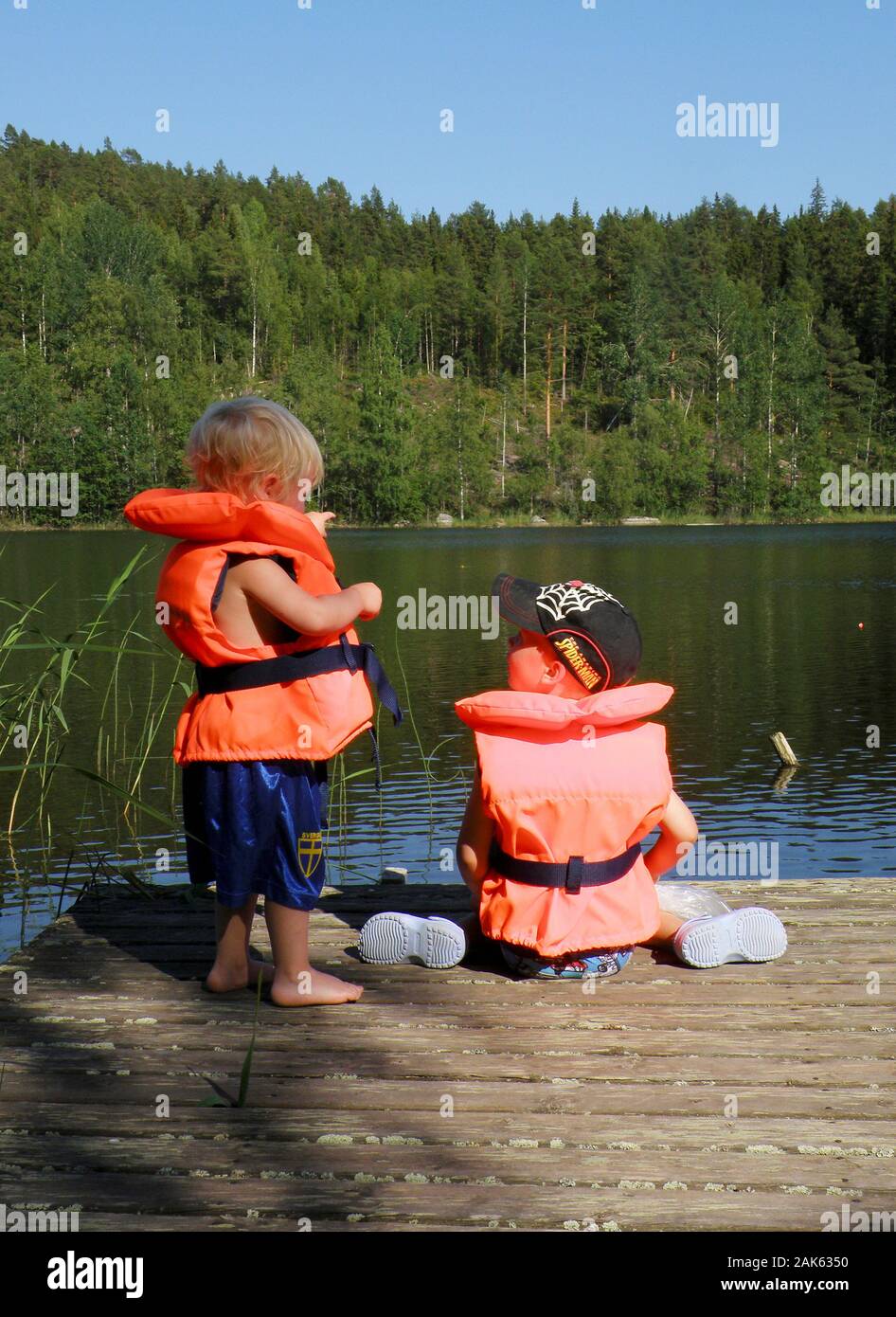 Boys fishing from a jetty Stock Photo - Alamy