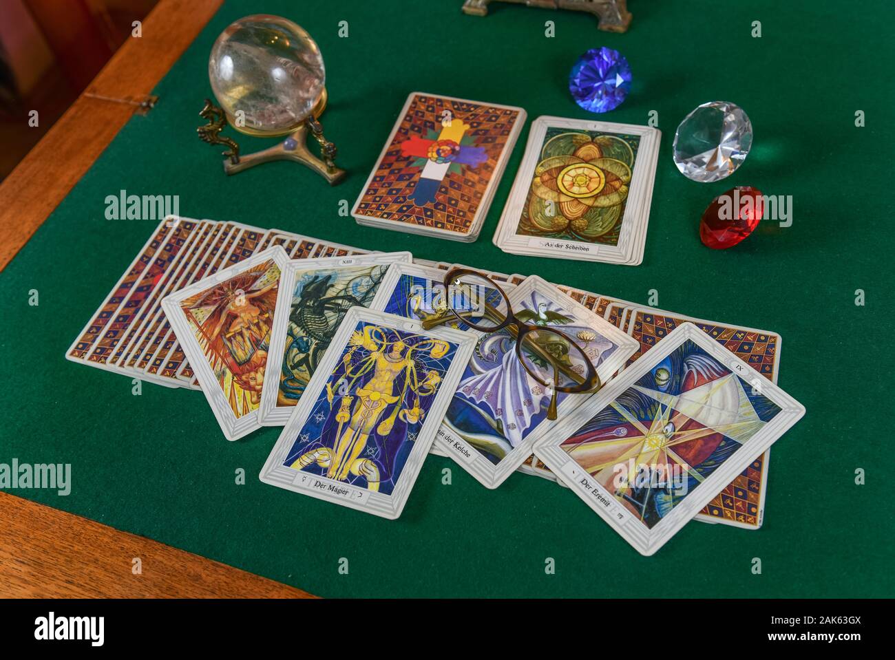 Predicting the future with tarot cards, cards and glass ball on a table ...