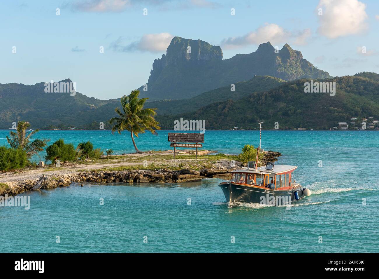 Water taxi at the airport, Airport Motu Mute, behind volcano Mont ...