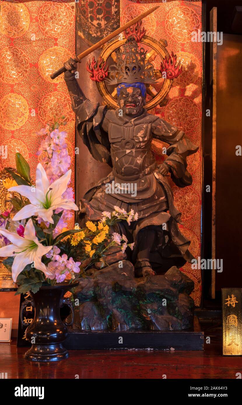Wooden statue depicting one of the Four Heavenly Kings buddhist deity ...