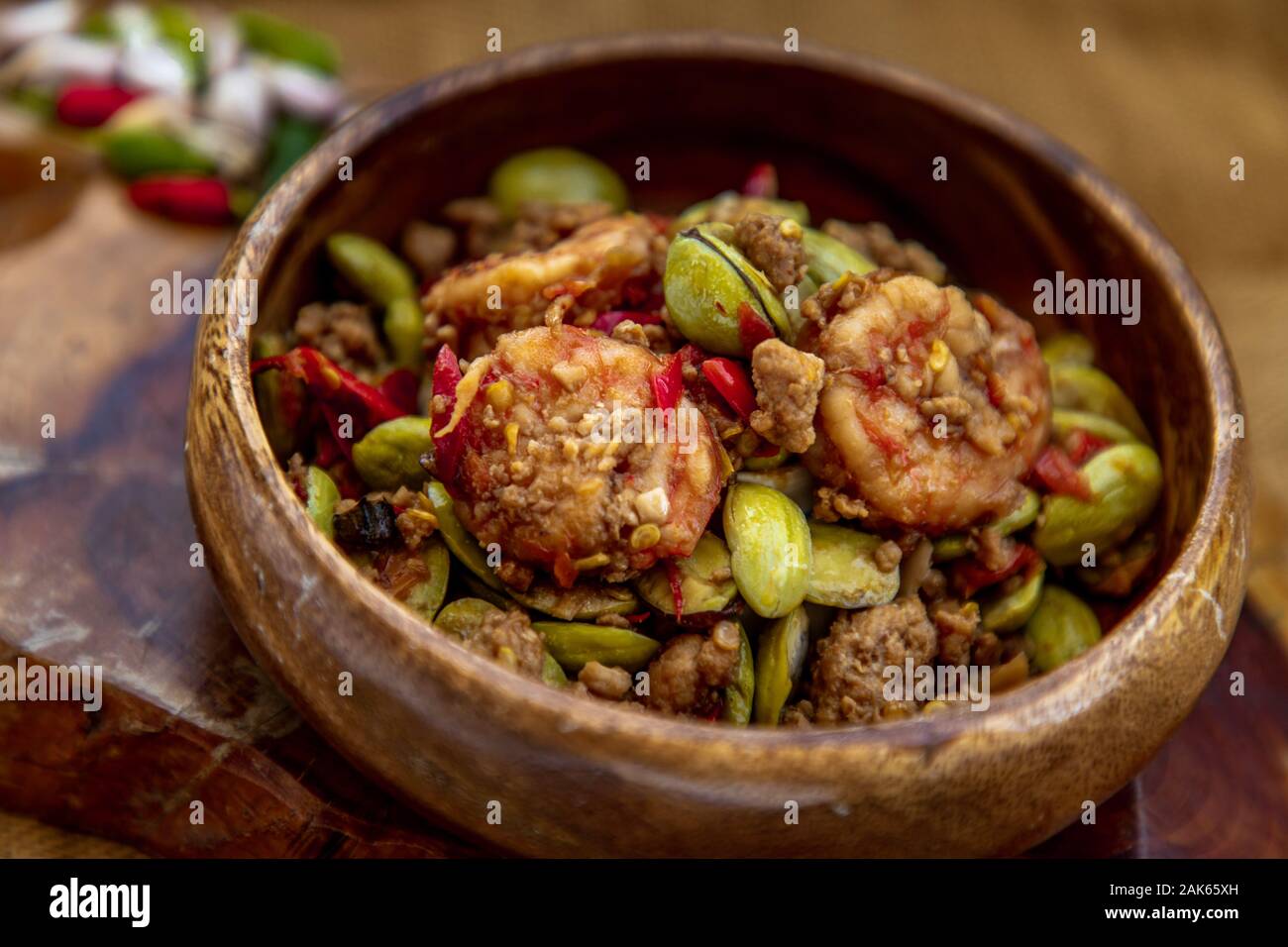 Stir Fried Bitter beans (Sator) with Shrimp in wooden bowl, It is a ...