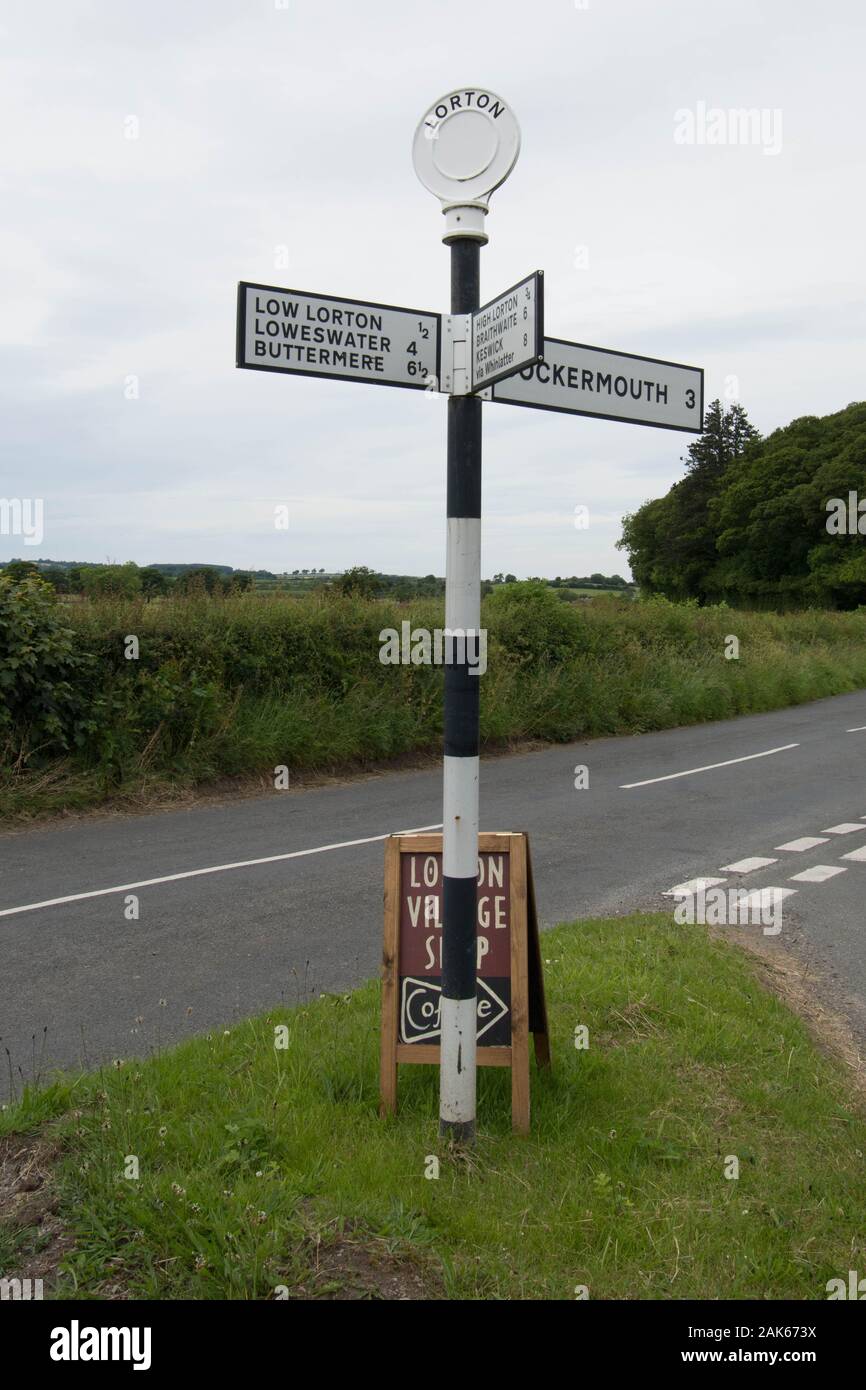 Sign posts Lake District Cumbria UK signs lake water hill hills outside ...